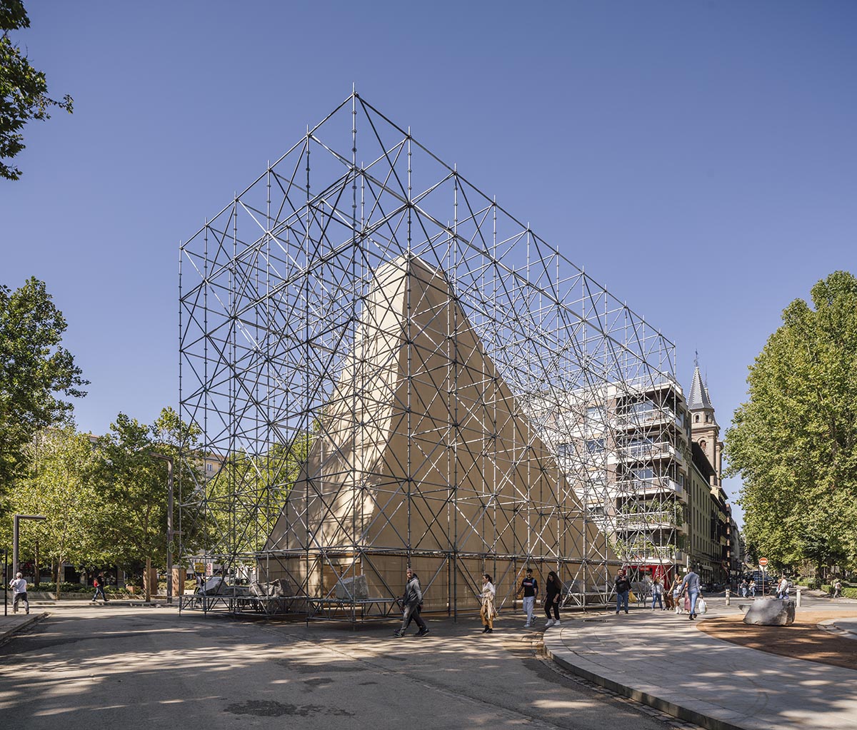 Unveiling the Unfinished Beauty: Giant Scaffolding Wraps Aire Pavilion ...